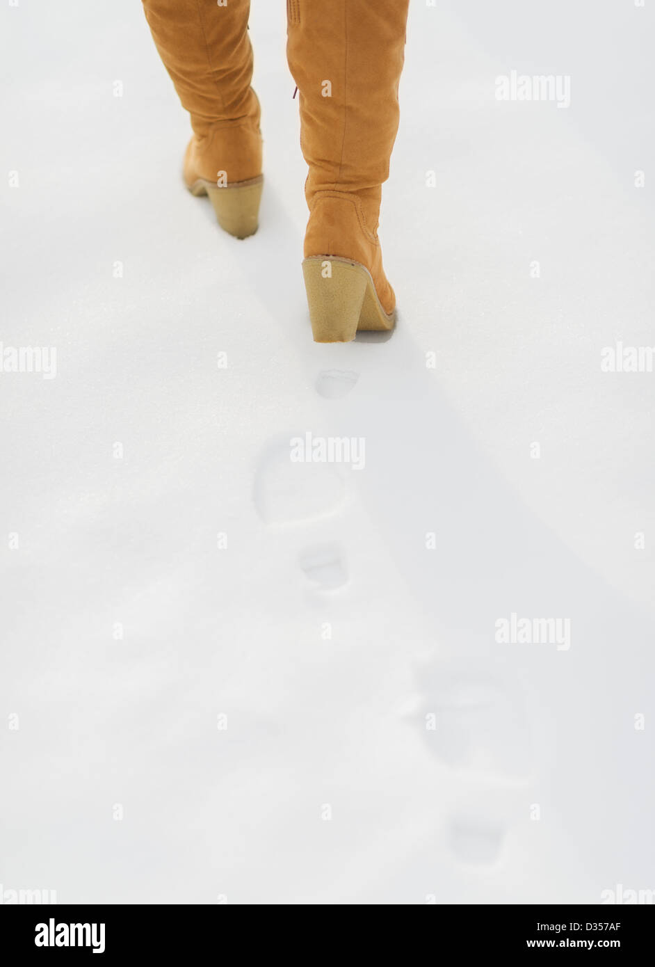 Closeup on female legs in winter boots walking on snow Stock Photo - Alamy