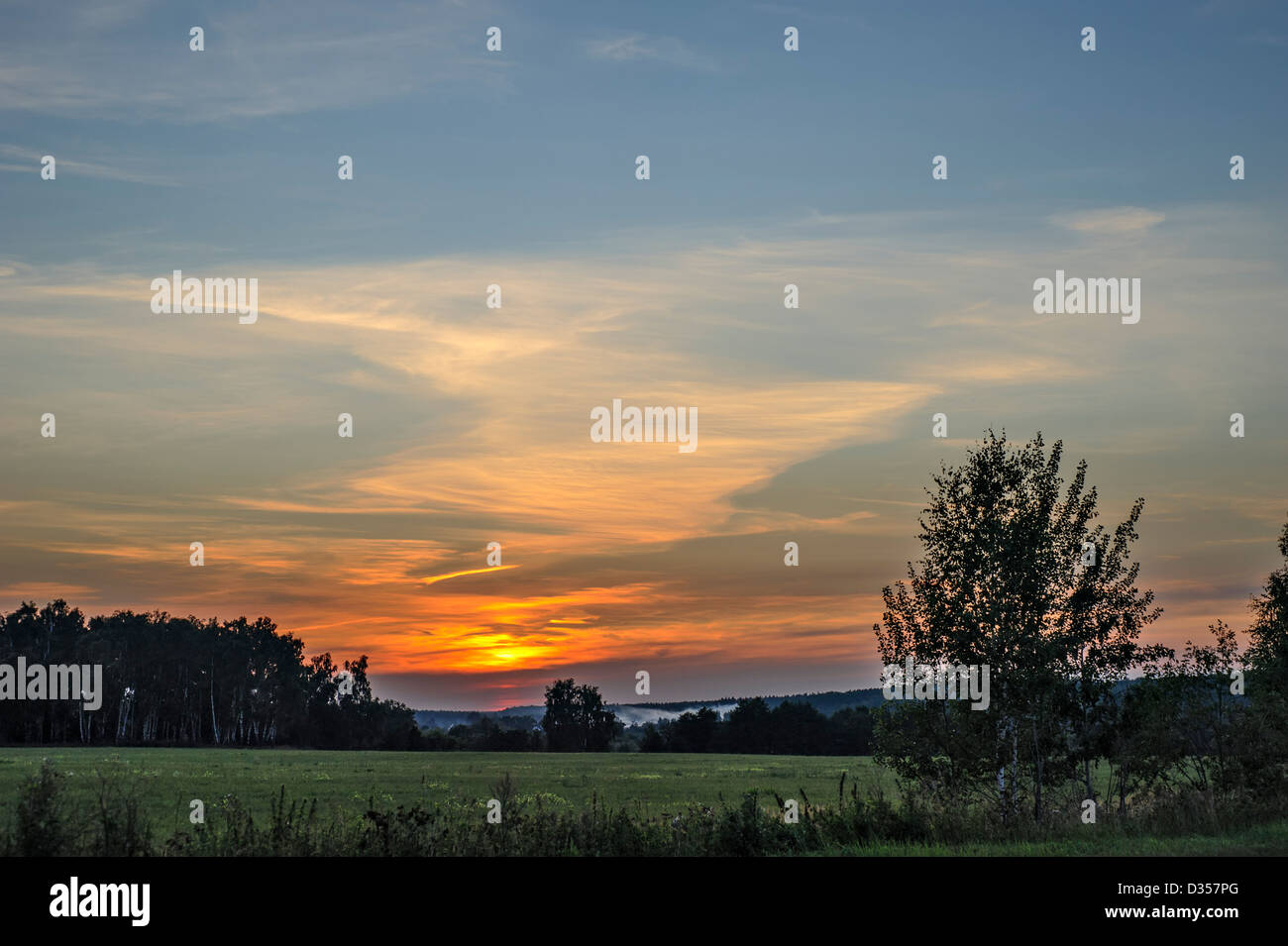 Sunset over nature landscape Stock Photo - Alamy