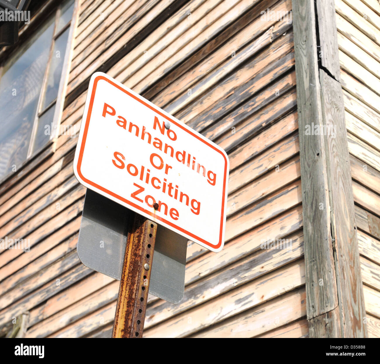 no panhandling or soliciting zone sign near wooden building Stock Photo ...