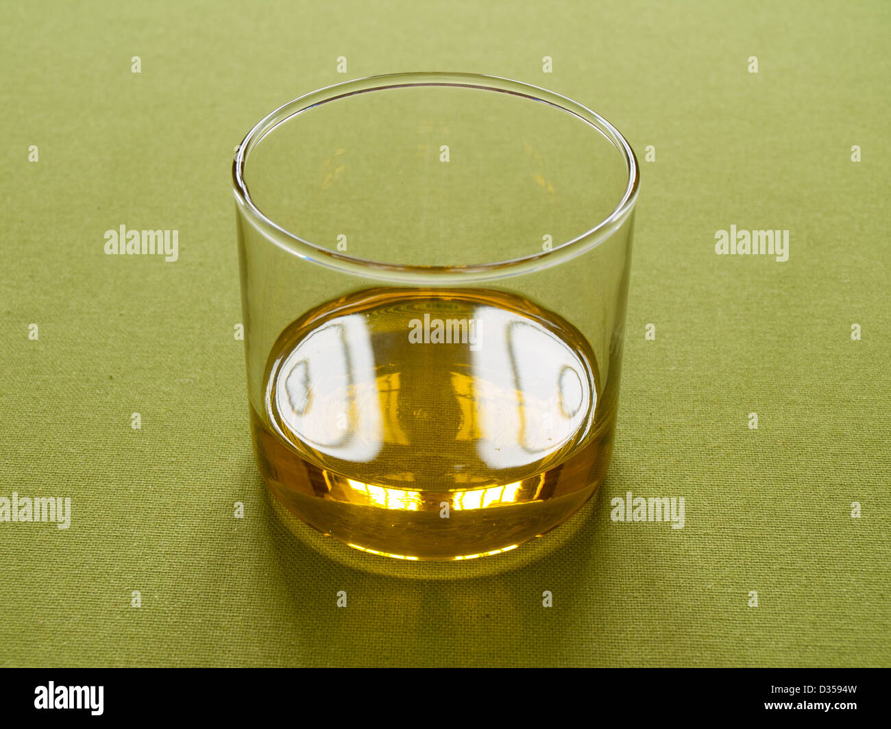 Close-up view of organic Italian extra virgin Olive Oil in a glass ...