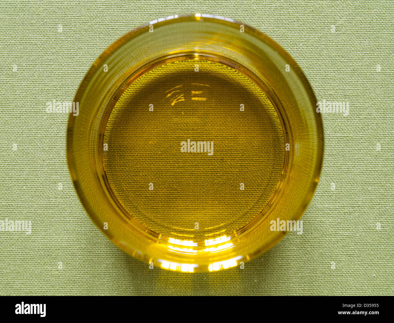 Close-up view of organic Italian extra virgin Olive Oil in a glass ...