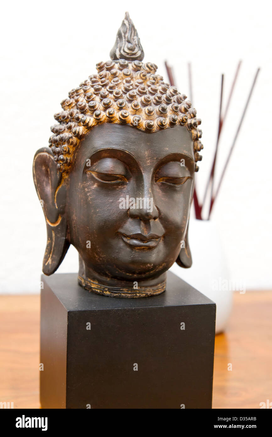 Buddha head and incense sticks Stock Photo - Alamy