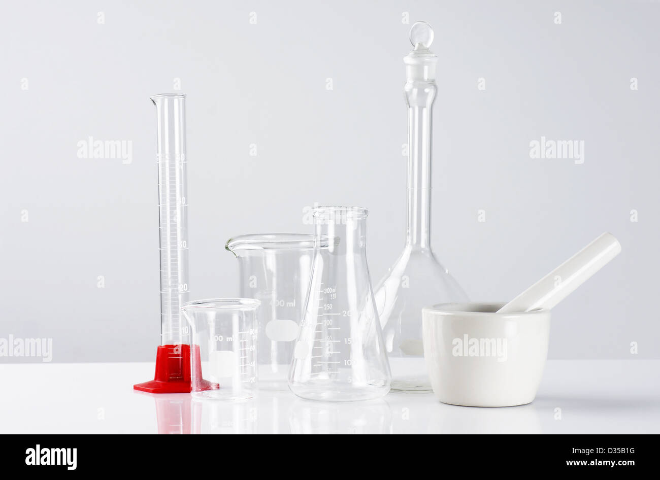 Science concept: empty laboratory glassware over light background ...