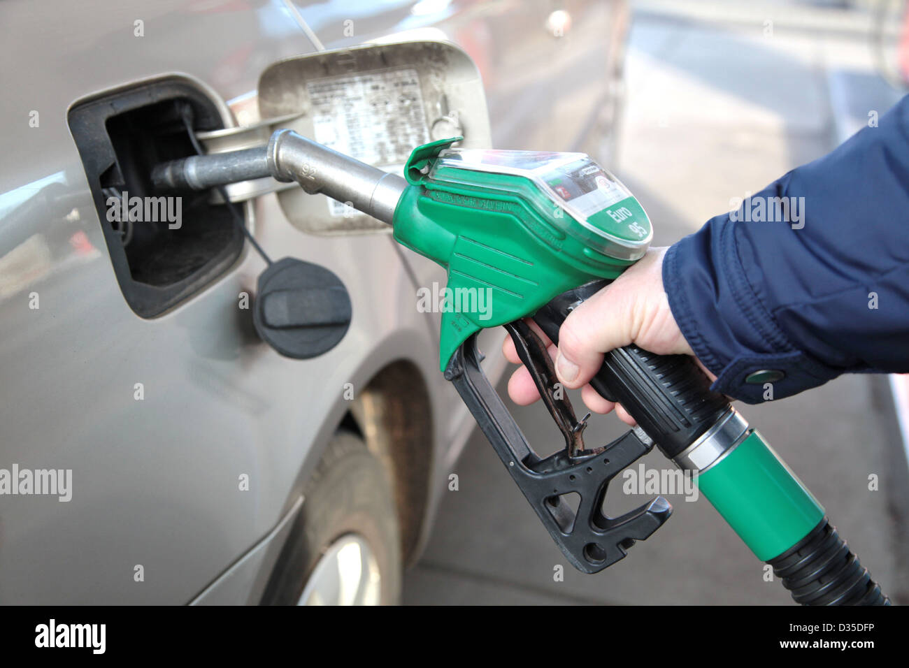 A man fills his car up with fuel at a gas station Stock Photo - Alamy