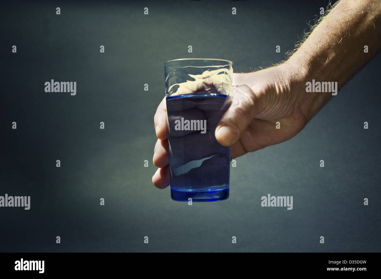 Hand with a glass of water Stock Photo - Alamy