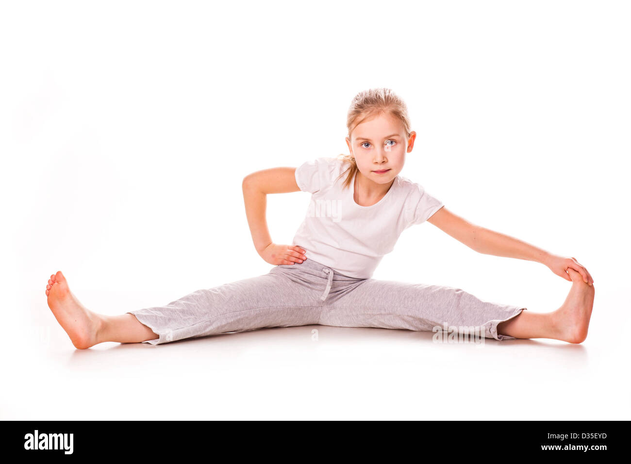Beautiful Girl Gymnast Exercising Stretching Isolated On White Stock
