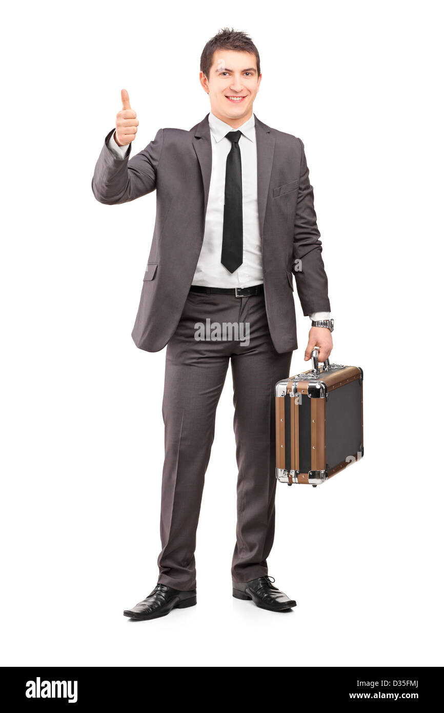 Full length portrait of a young businessman holding a briefcase and ...