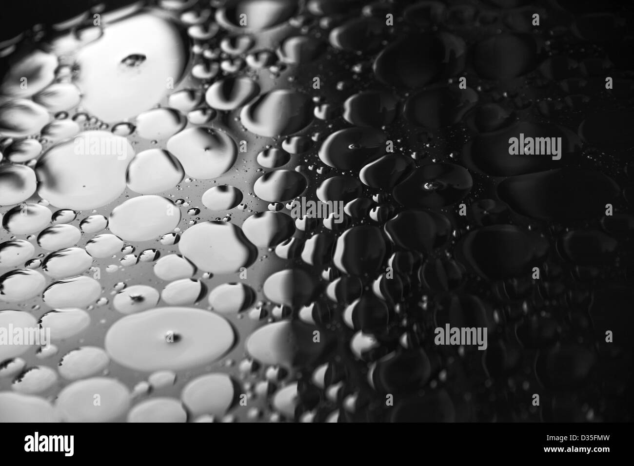Oil floating on water Stock Photo - Alamy