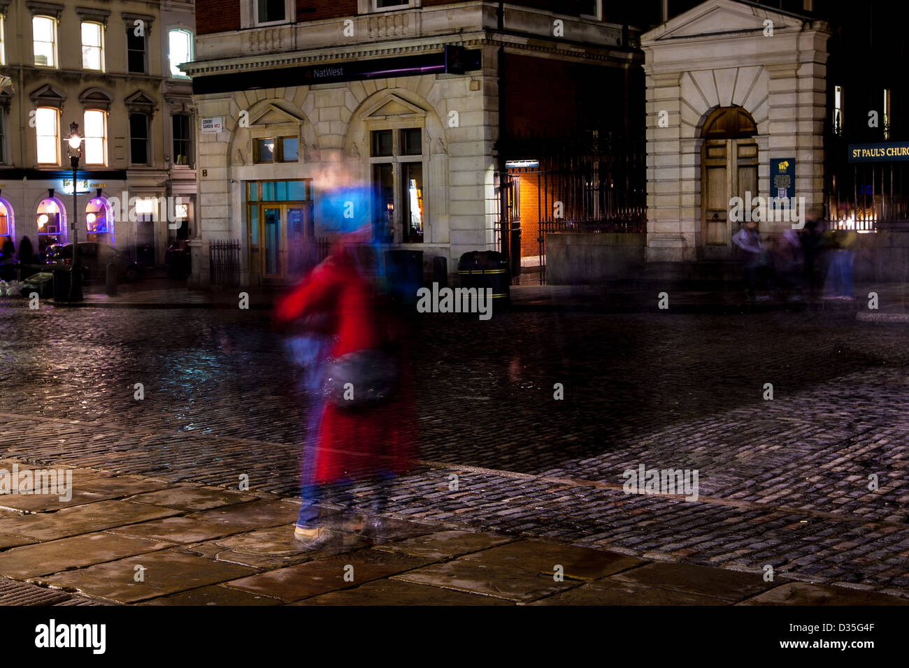 Ghostly couple cuddle in Covent Garden in London at night Stock Photo ...