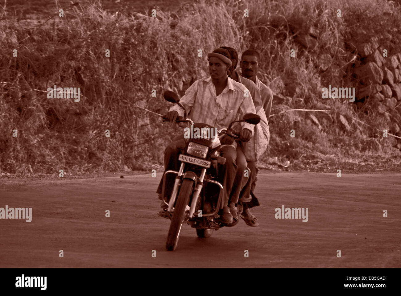 Four men riding on a bike, India Stock Photo - Alamy