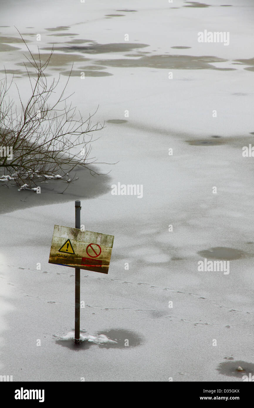 Beware deep water sign surrounded by ice Stock Photo - Alamy