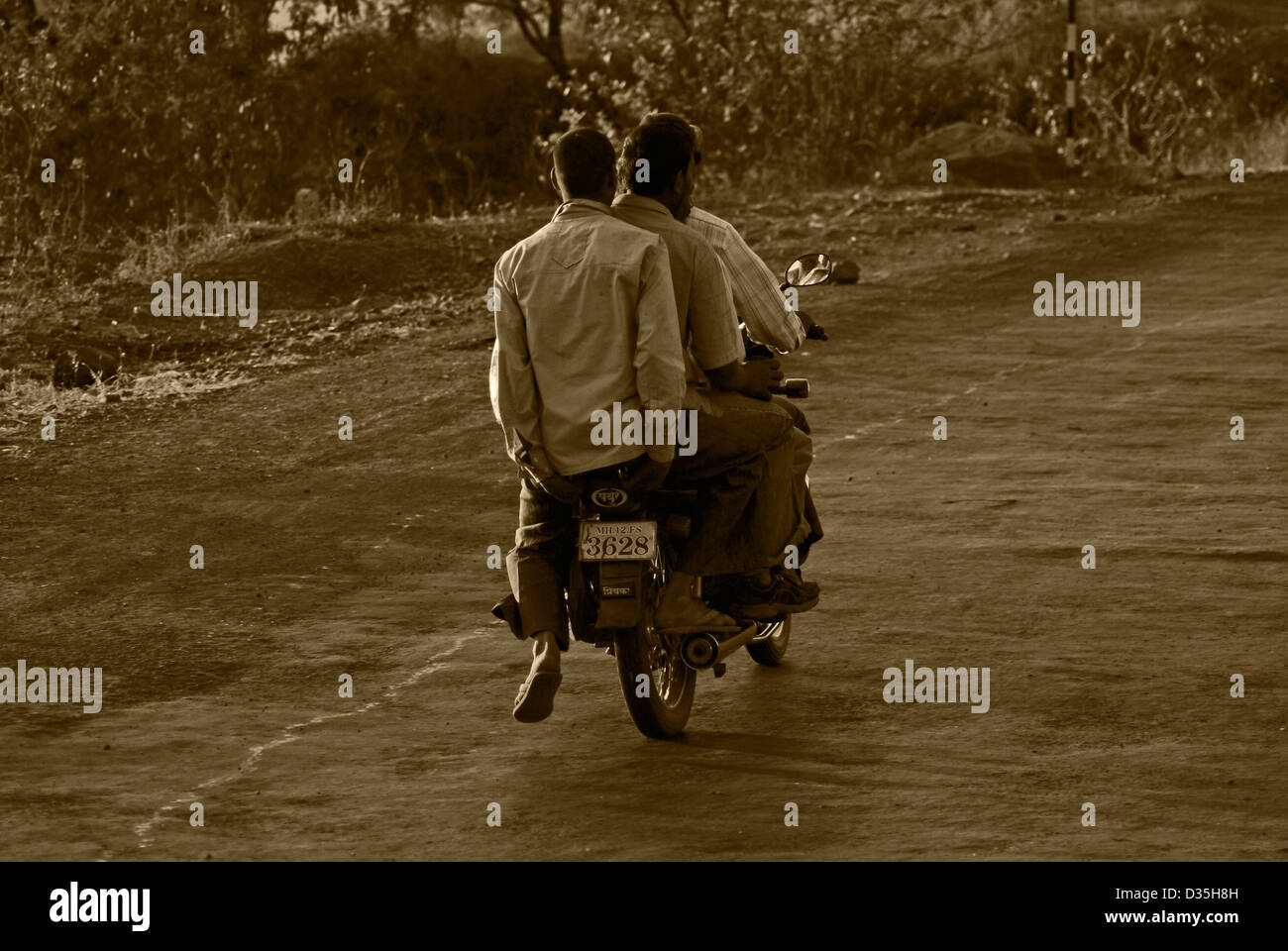 Four men riding on a bike, India Stock Photo - Alamy