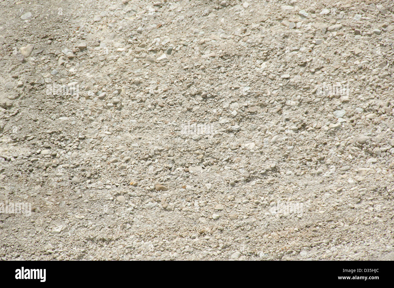 background of sandy limestone in sunlight with small and big stones ...