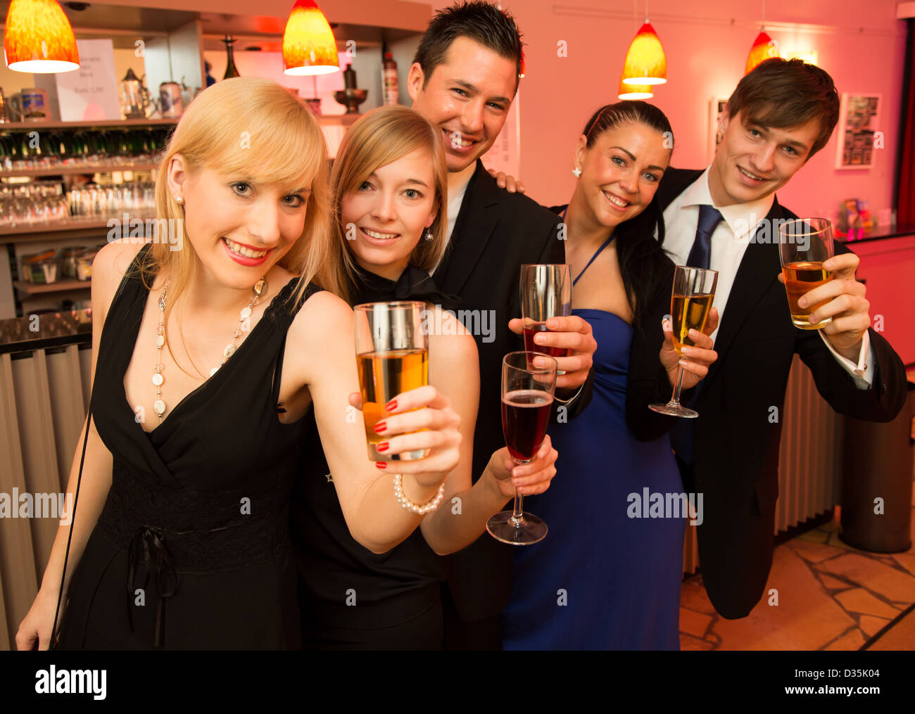 Group of five people drinking and celebrating in a bar Stock Photo - Alamy