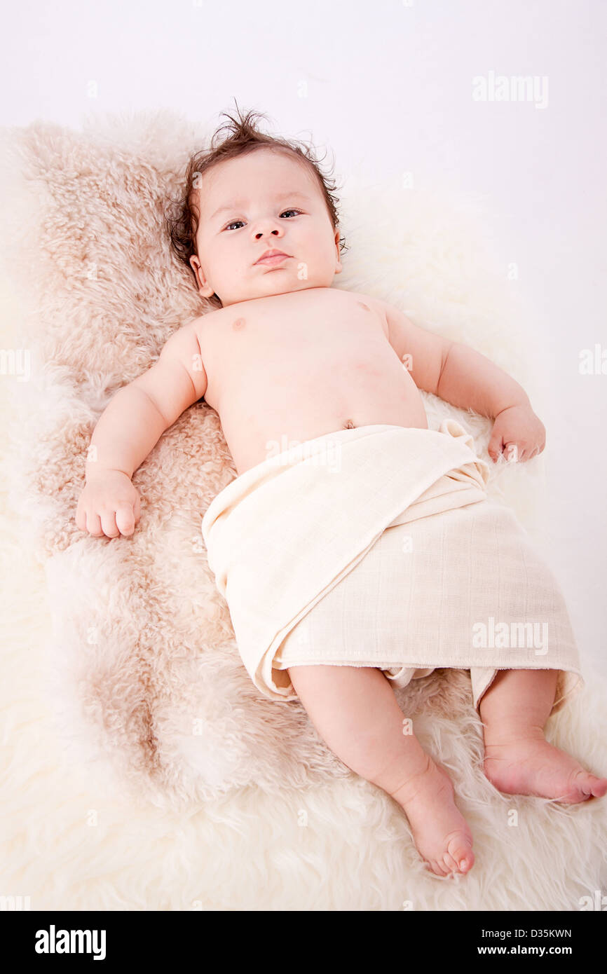 cute little baby infant toddler lying on white blanket smiling portrait ...