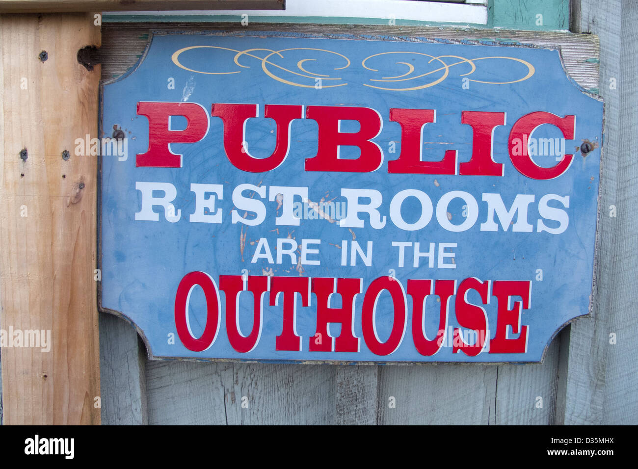 Public rest rooms are in the outhouse sign Stock Photo - Alamy