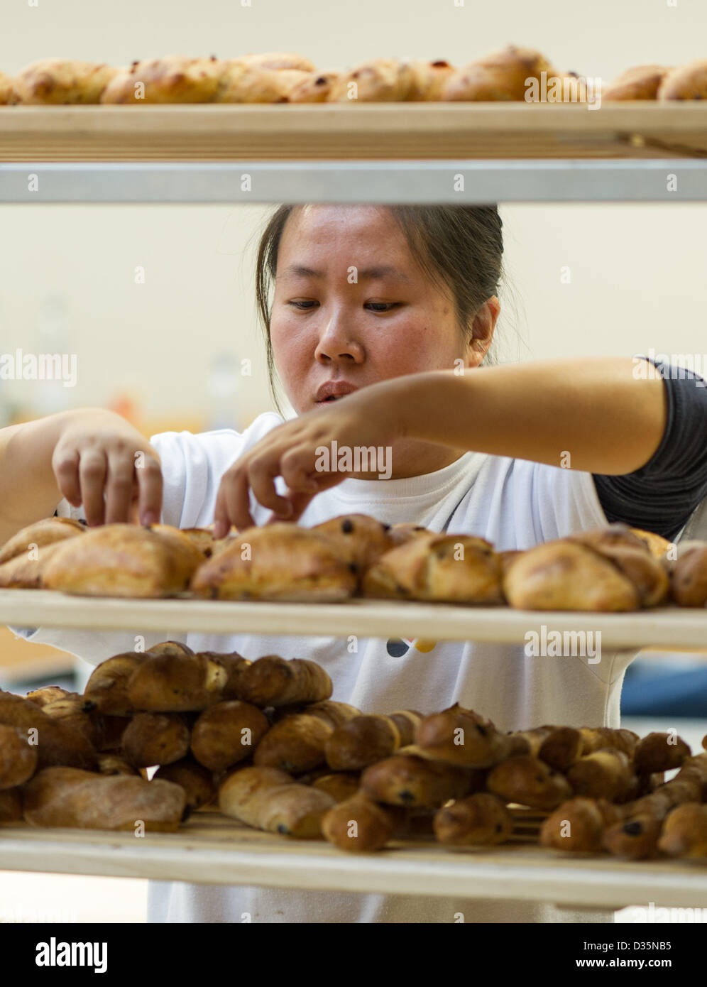 A participant of an international baking seminar stands behind baking ...