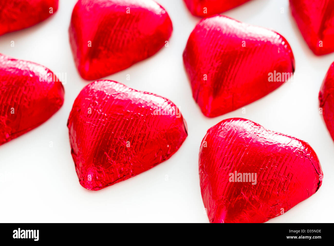 Heart shape chocolate candies on white background Stock Photo - Alamy