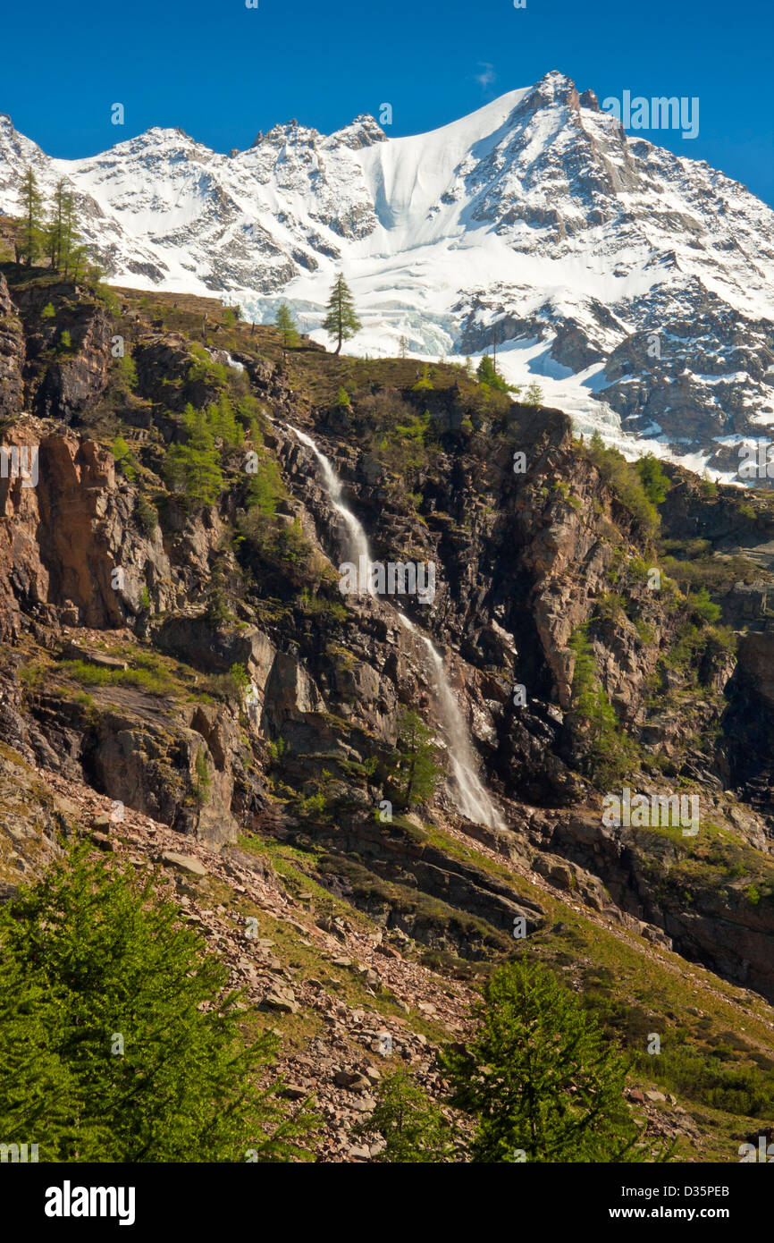 Waterfall during the spring thaw in Valnontey valley, Gran Paradiso National Park, Western Alps ...