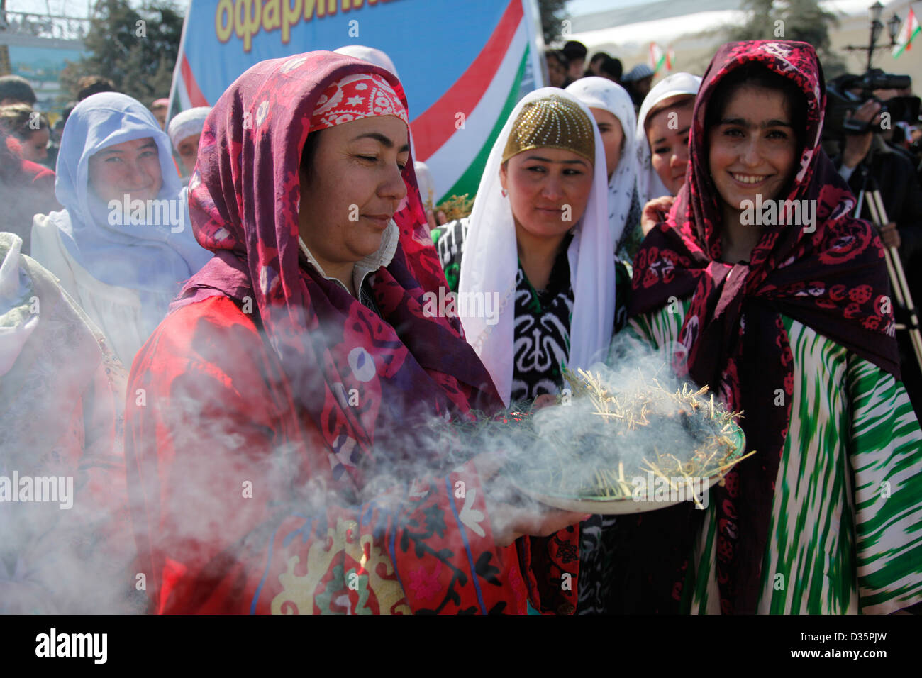Women burning esphand incense during a Navruz celebration near Dushanbe ...