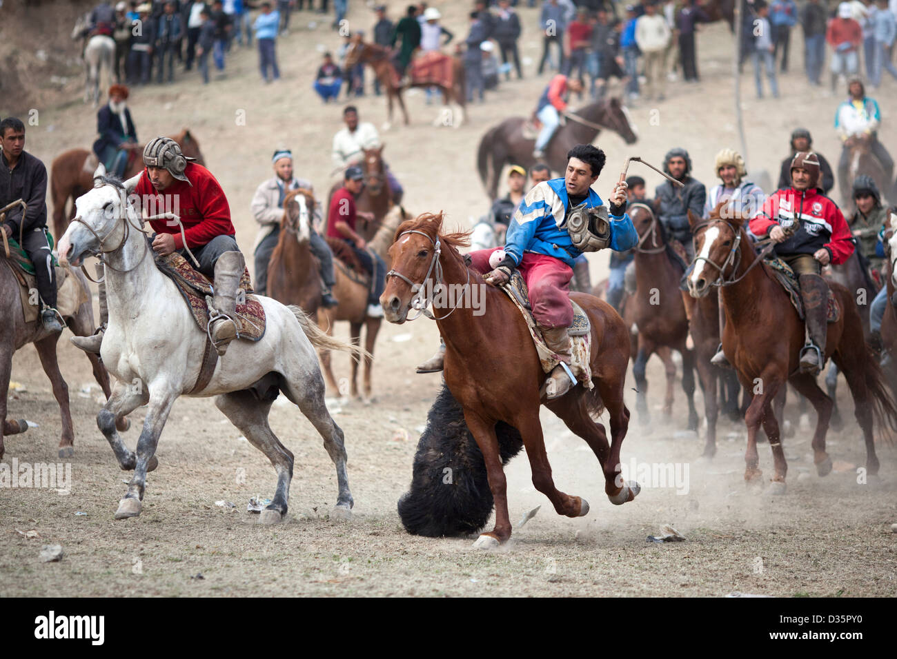 Buzkashi players fight for possession of a goat carcass during a Navruz ...