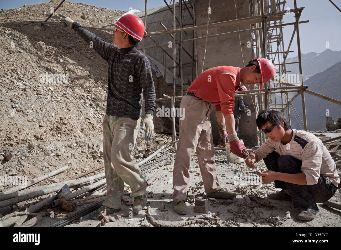 Chinese road construction workers paving constructing roads and tunnels ...