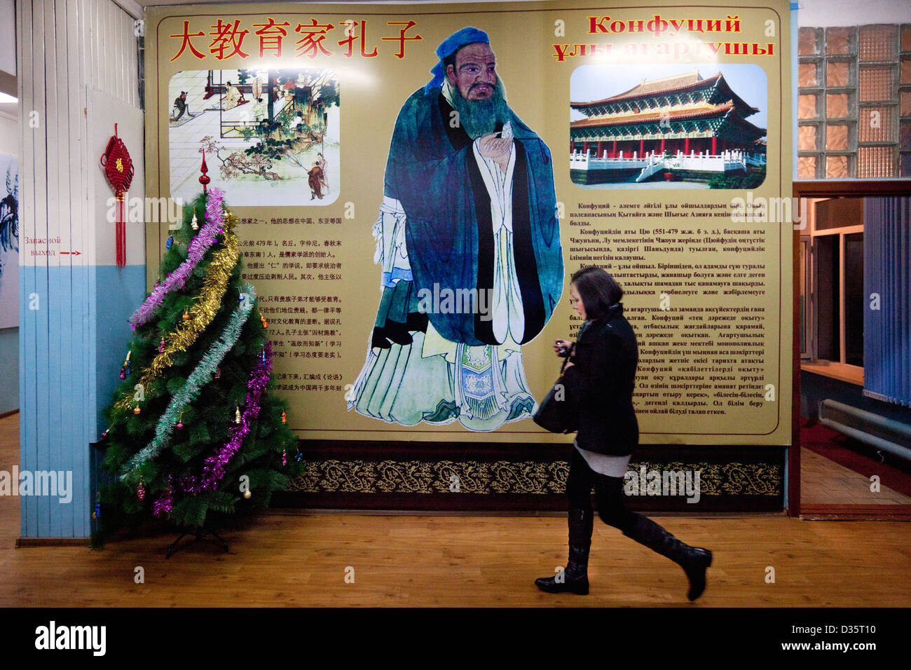 A language student walks by a mural of Confucius at the 'Confucius ...