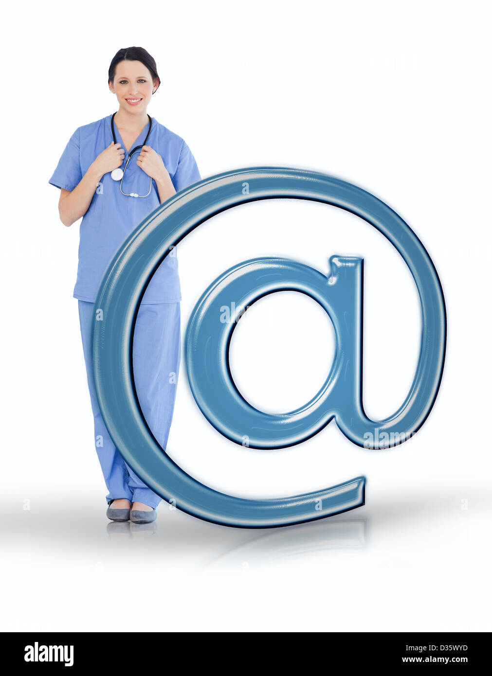 Nurse in scrubs standing beside email at symbol Stock Photo - Alamy