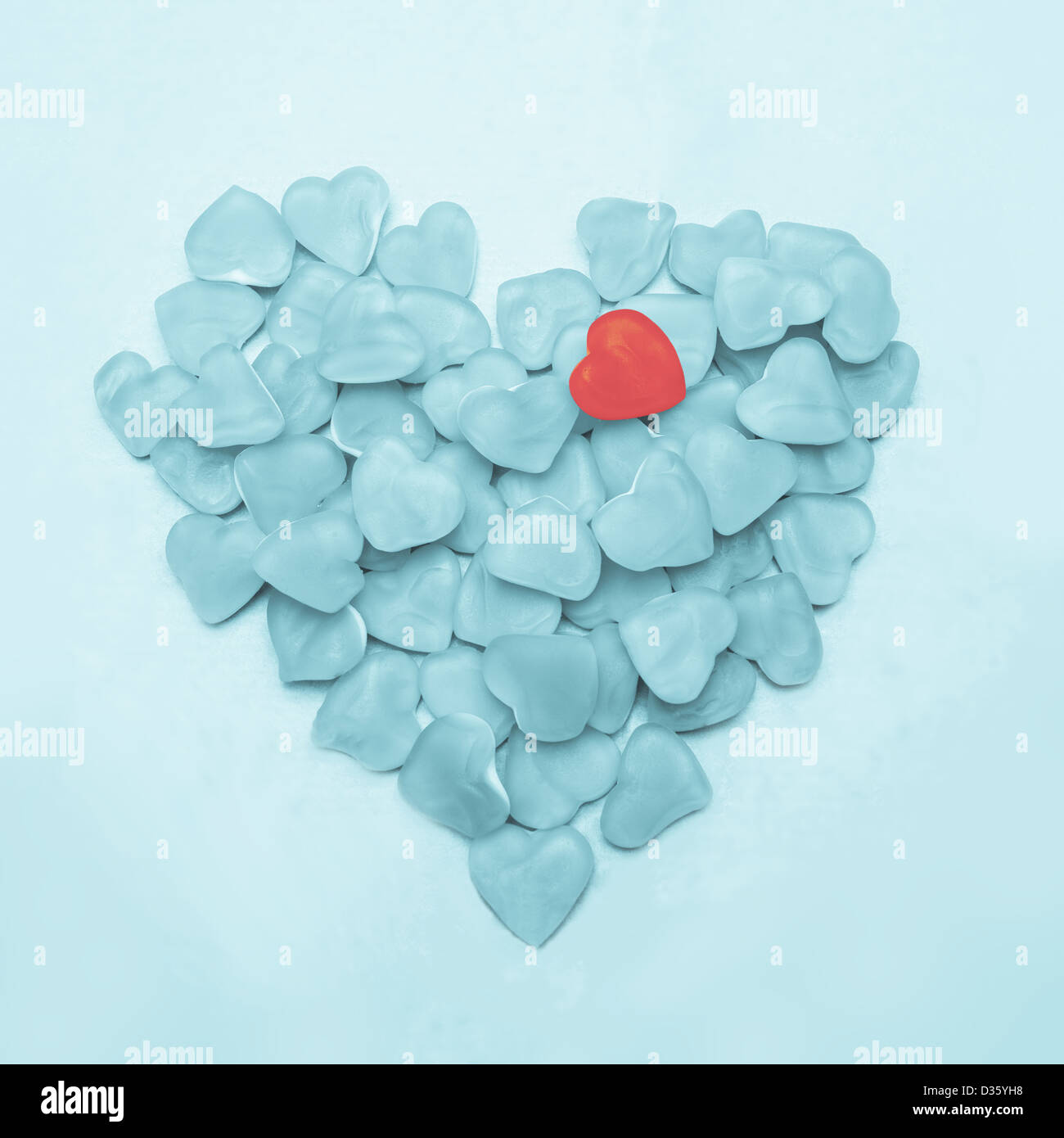 Blue heart made of candy with one pink heart Stock Photo - Alamy