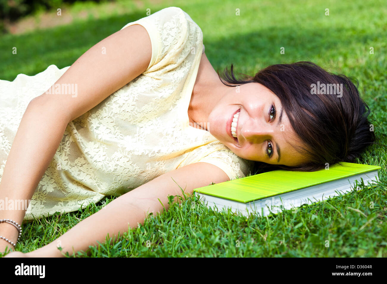 Student relaxing on the grass Stock Photo - Alamy