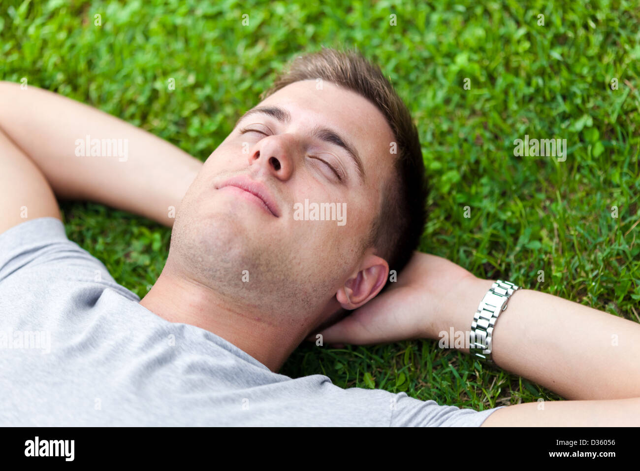 Student relaxing on the grass Stock Photo - Alamy