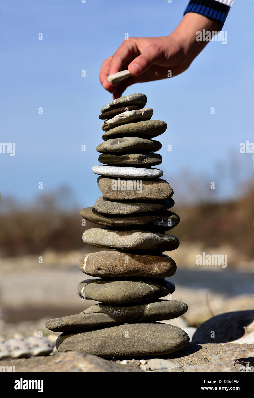 Balanced Stones. Stack of volcanic pebbles on seashore Stock Photo - Alamy