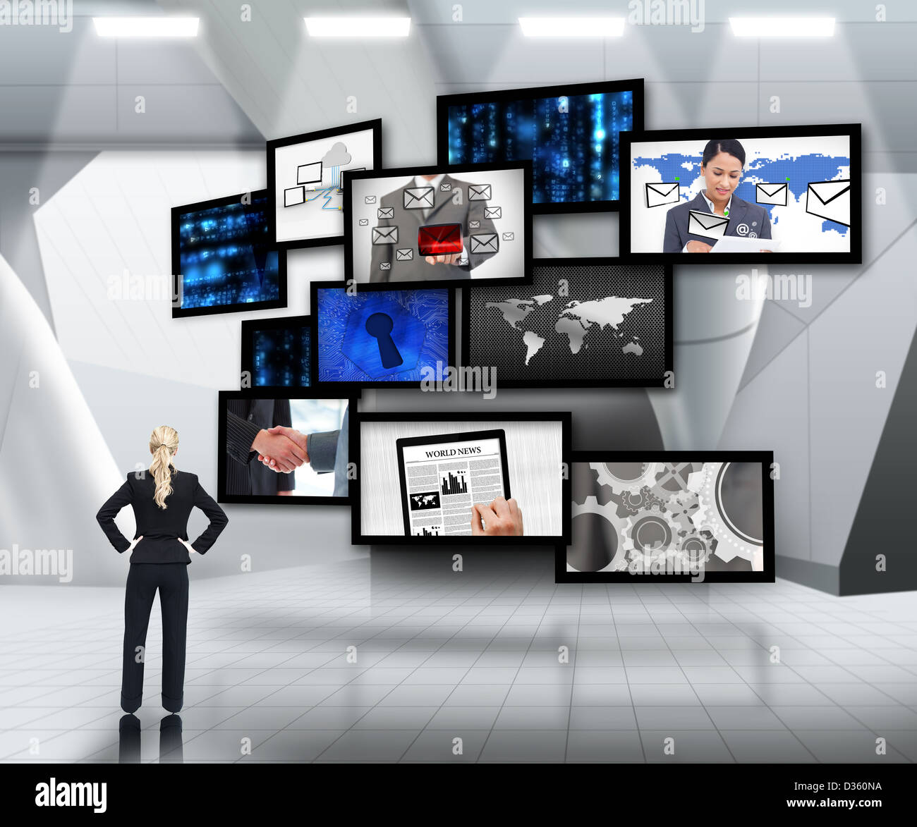 Businesswoman looking up at screens Stock Photo - Alamy