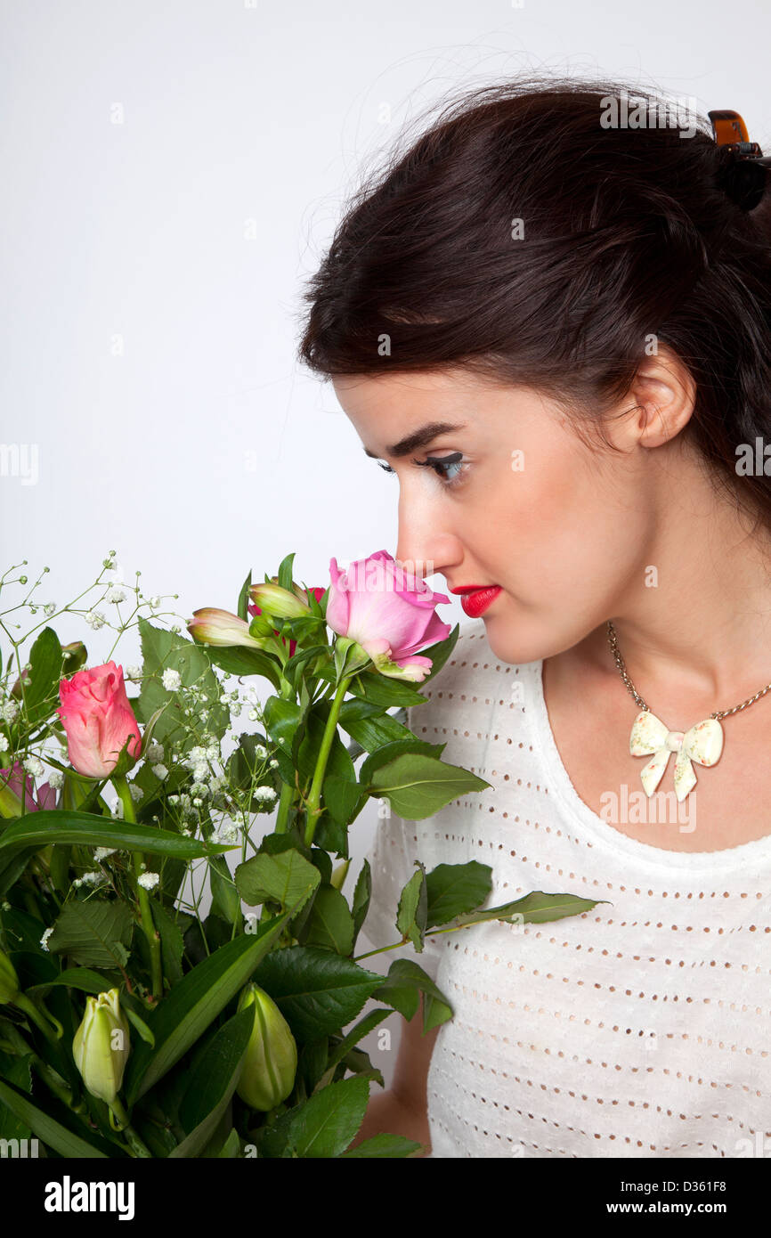 Woman Smelling Rose on Bunch of Flowers Stock Photo - Alamy