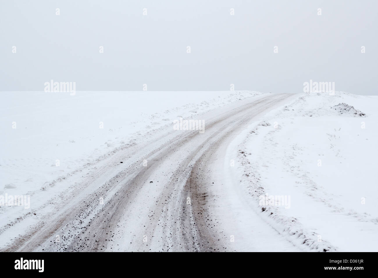 overcast winter landscape with rural road ending on horizon Stock Photo ...