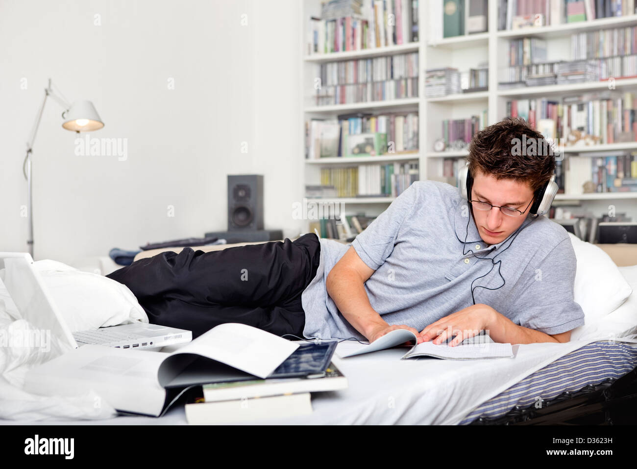 Young male student studying at home Stock Photo - Alamy