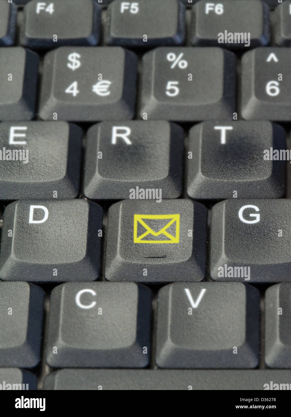 Yellow email button on keyboard Stock Photo - Alamy