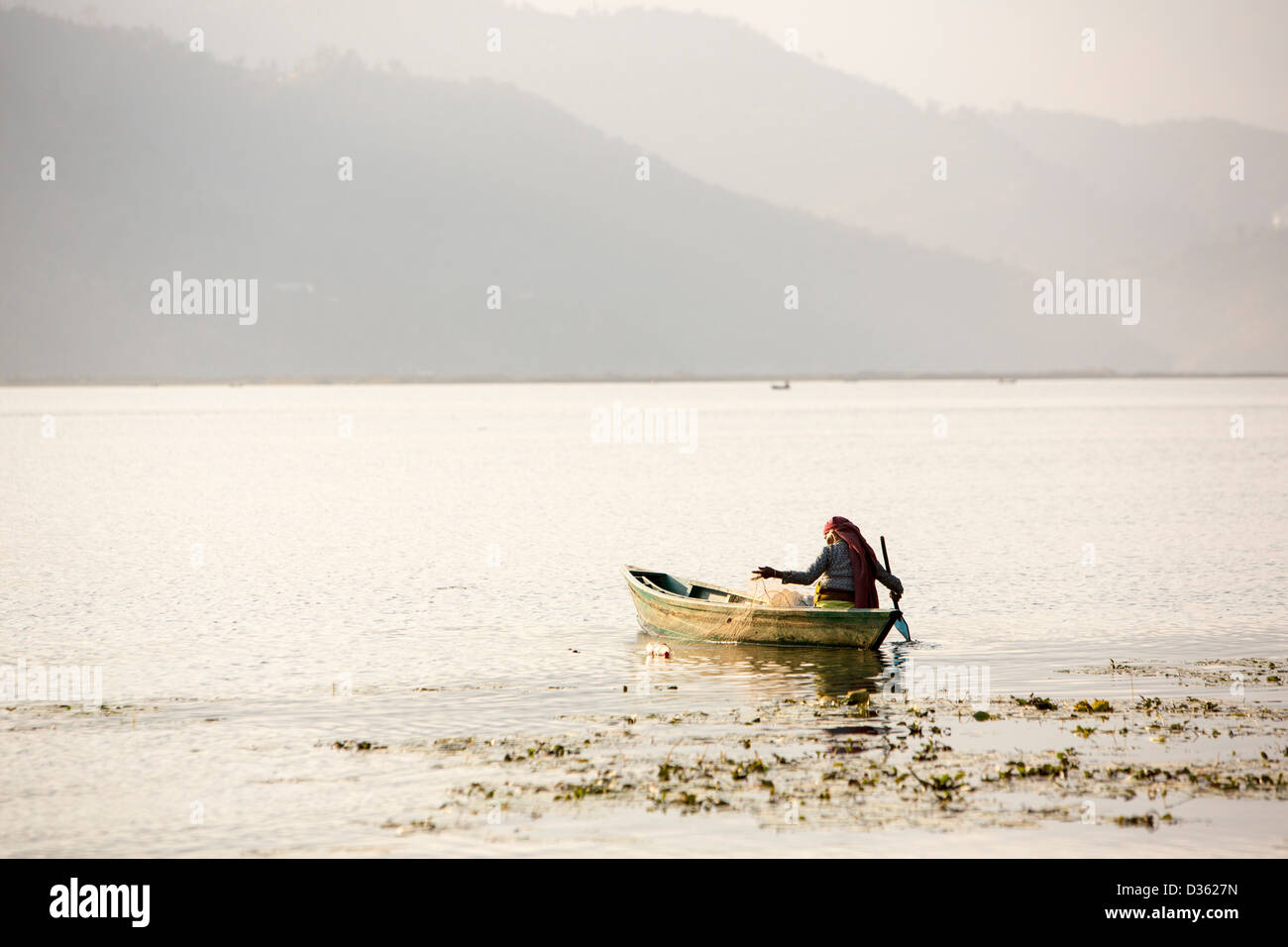 An old woman fishing on Phewa Lake, Pokhara, Nepal Stock Photo - Alamy