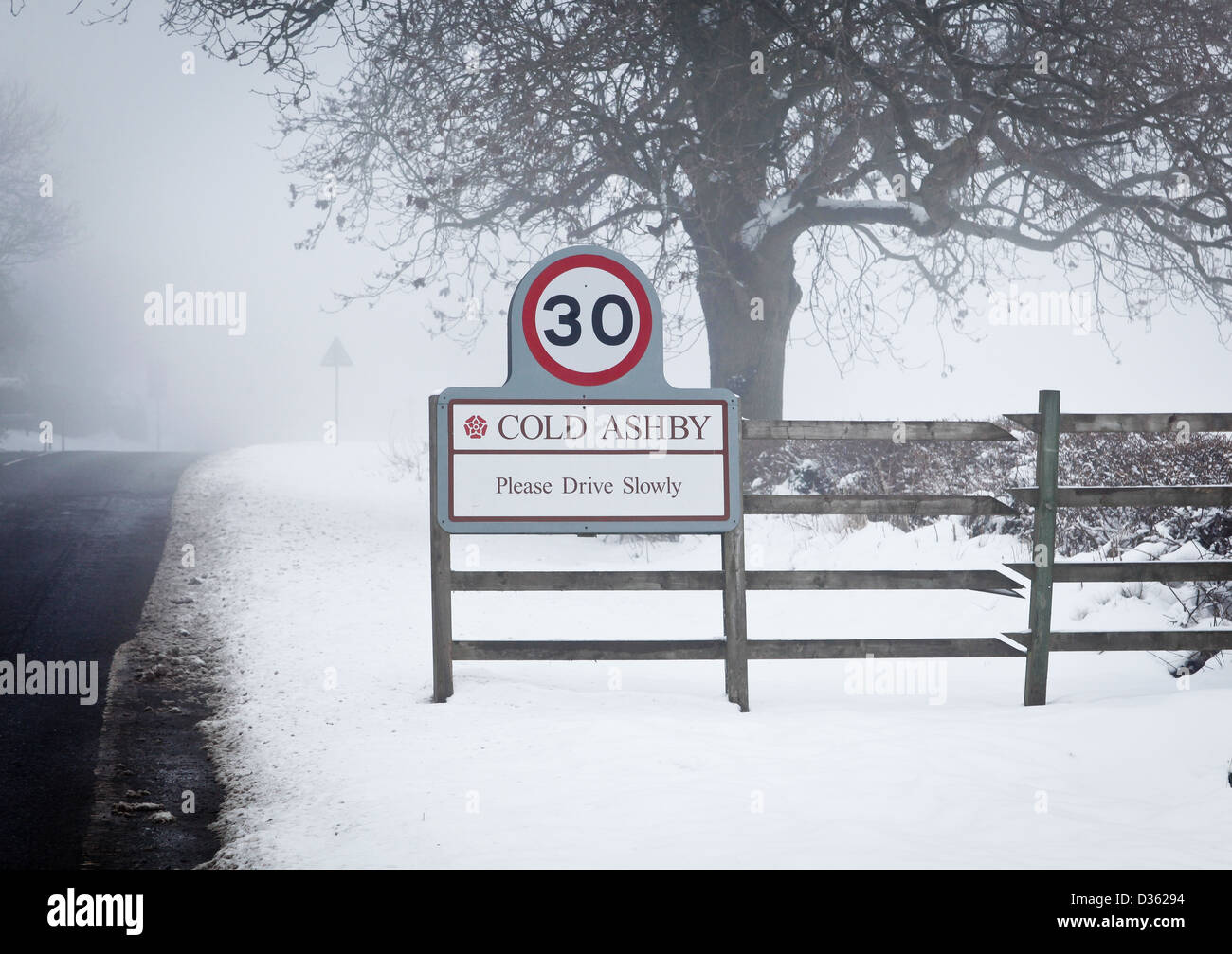 Snowy scene with village sign for Cold Ashby in Northamptonshre Stock ...