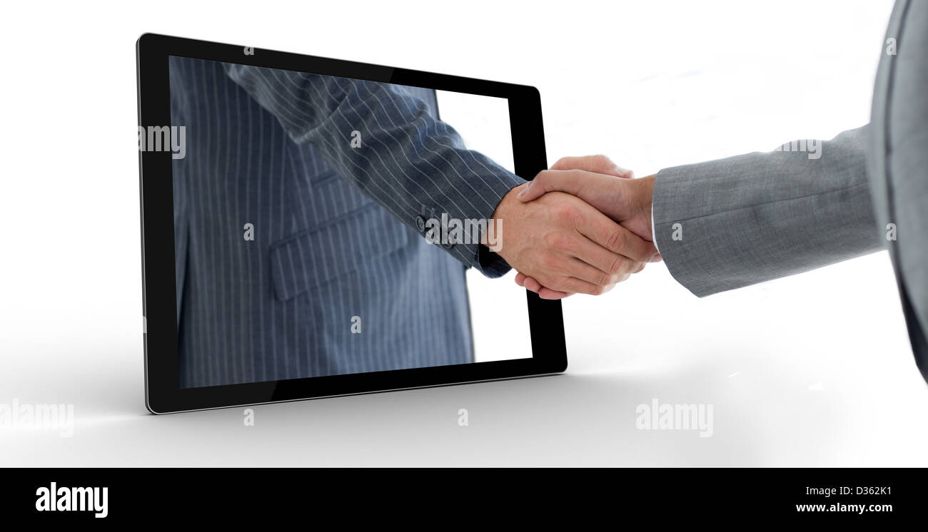 Businessman reaching out from tablet and shaking hands Stock Photo - Alamy