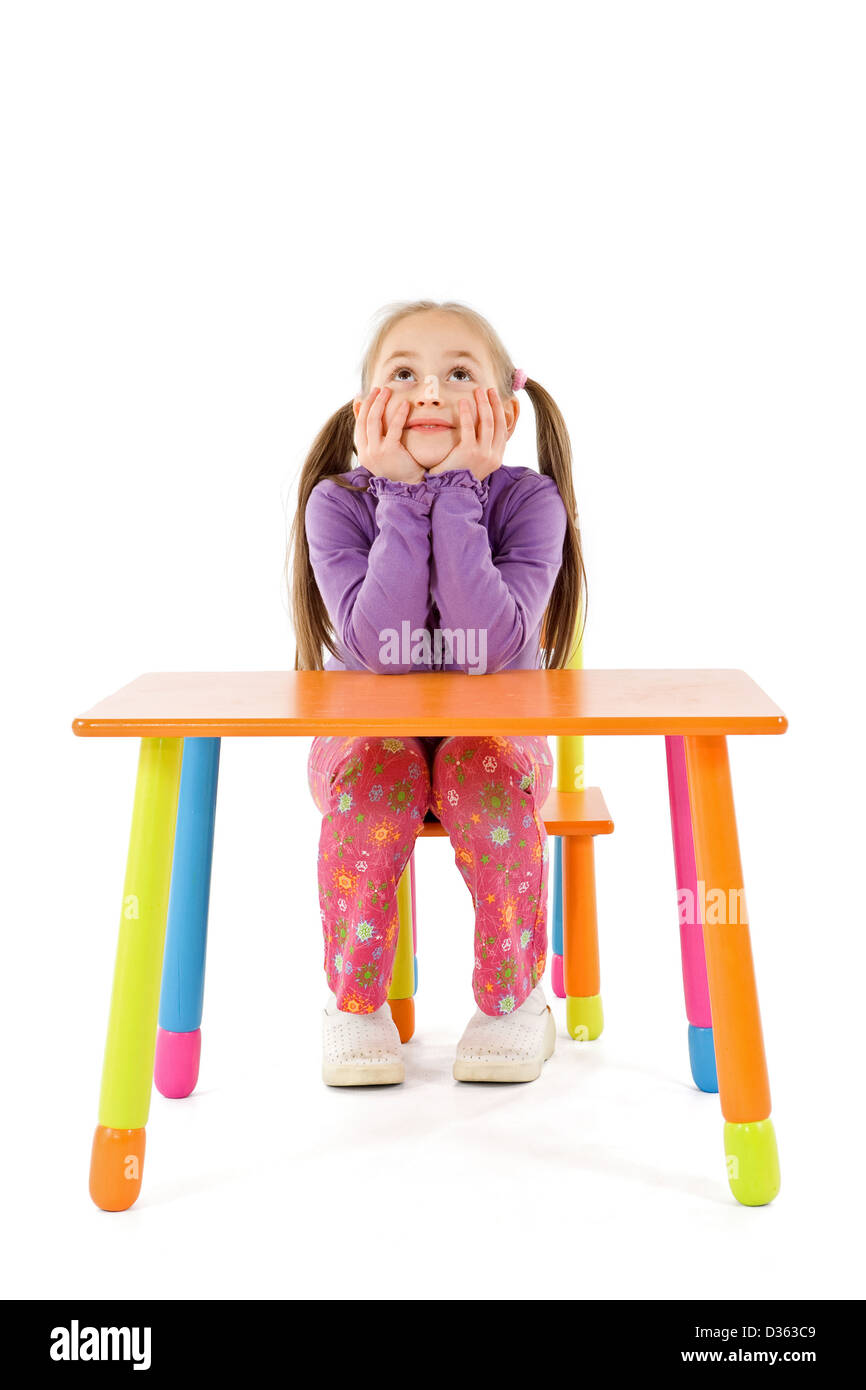 Pretty girl sitting, looking up and thinking Stock Photo - Alamy