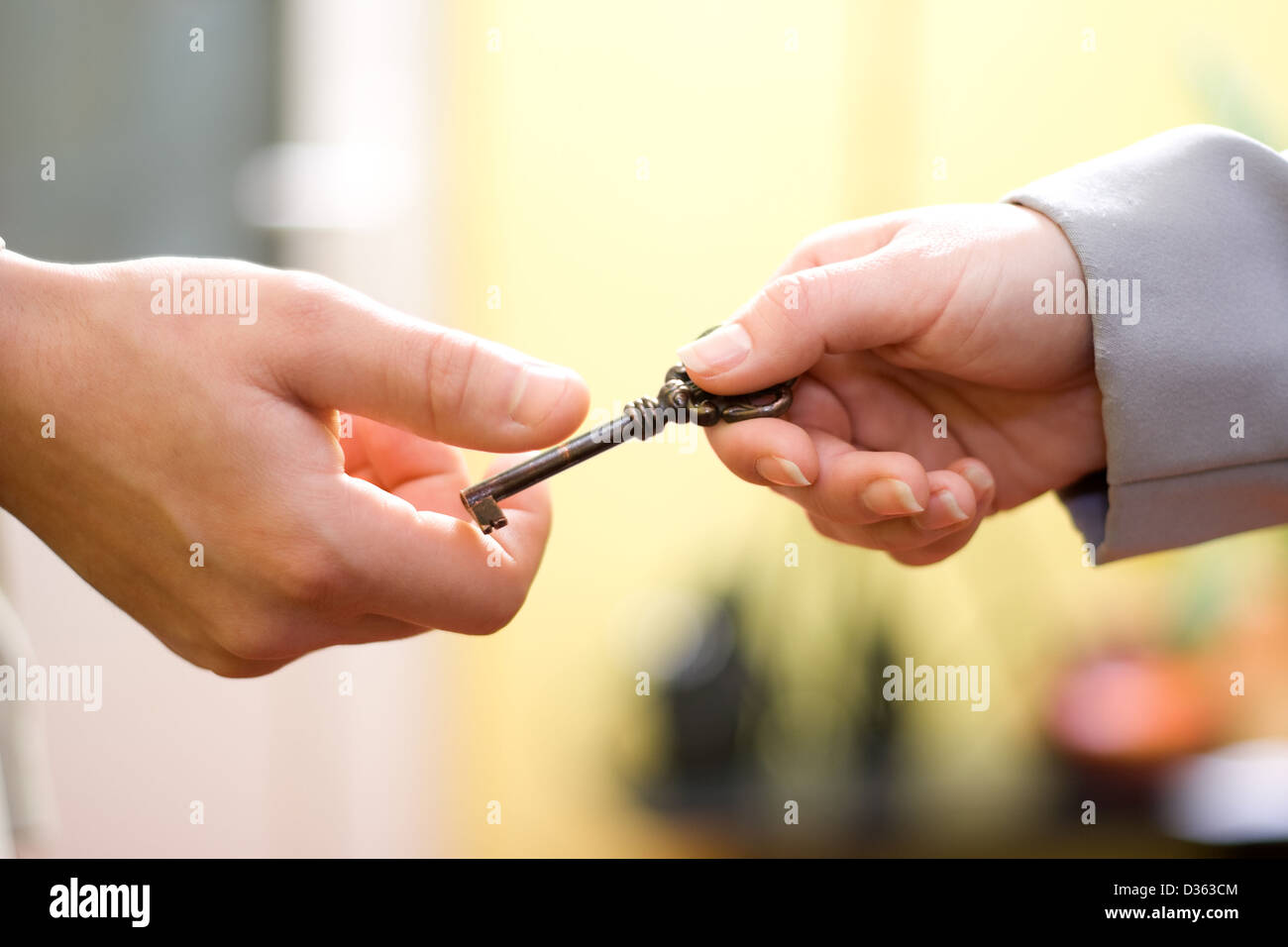 Hands exchanging the key to success Stock Photo - Alamy