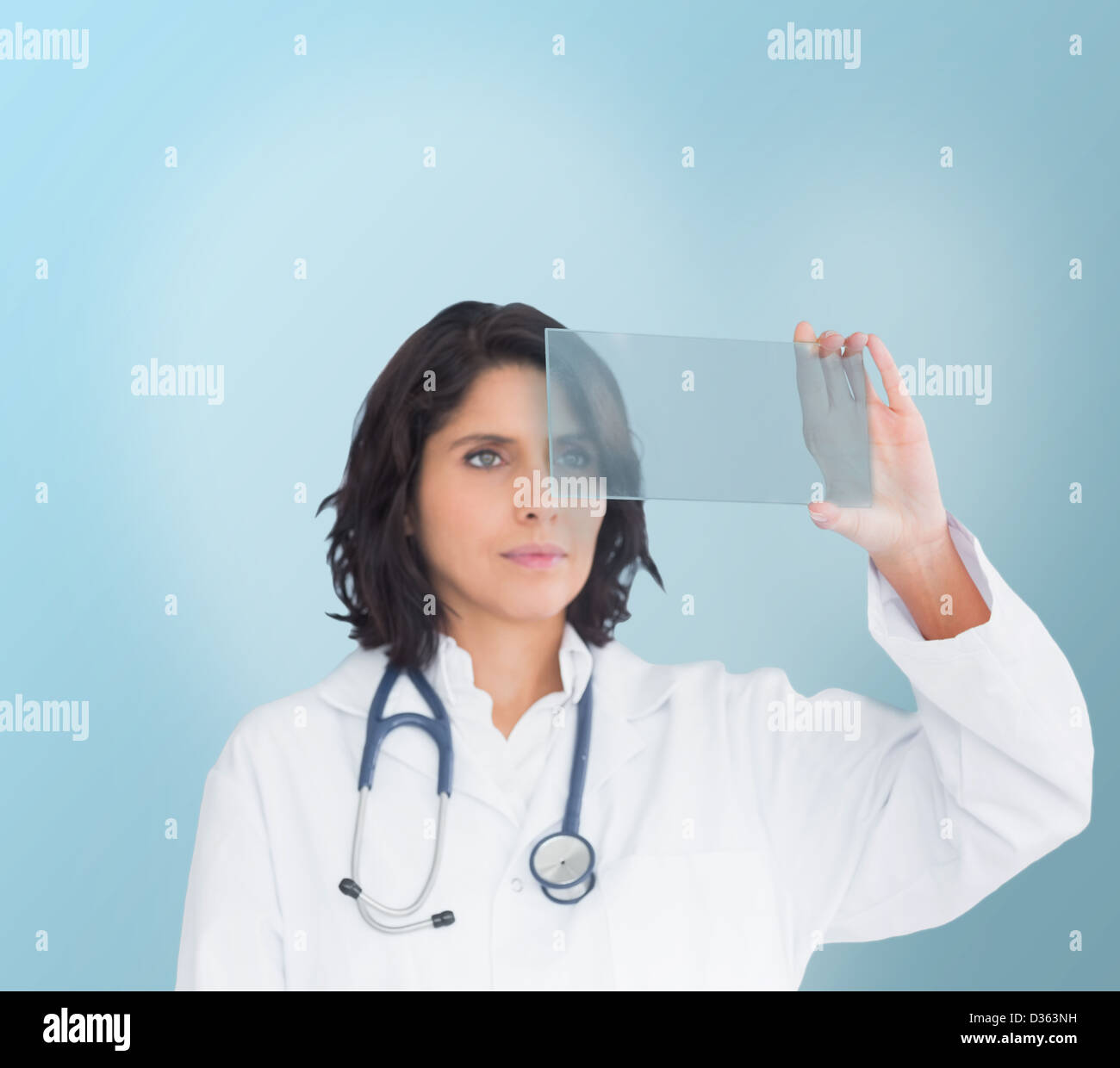 Brunette doctor looking at a screen Stock Photo - Alamy