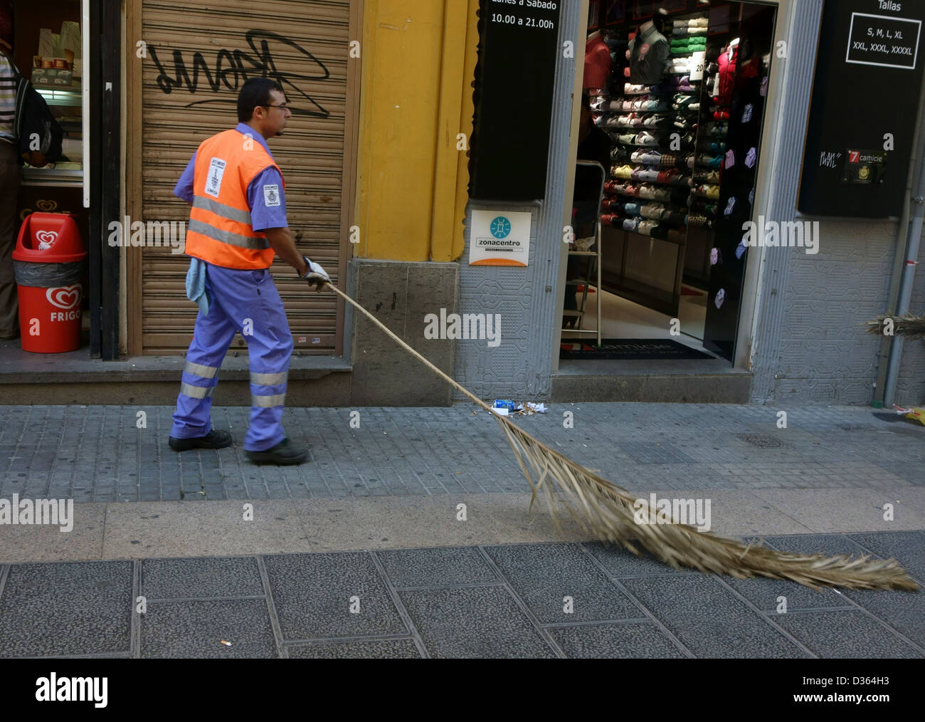 Street cleaner using palm leaf to sweep pavement in Santa Cruz ...