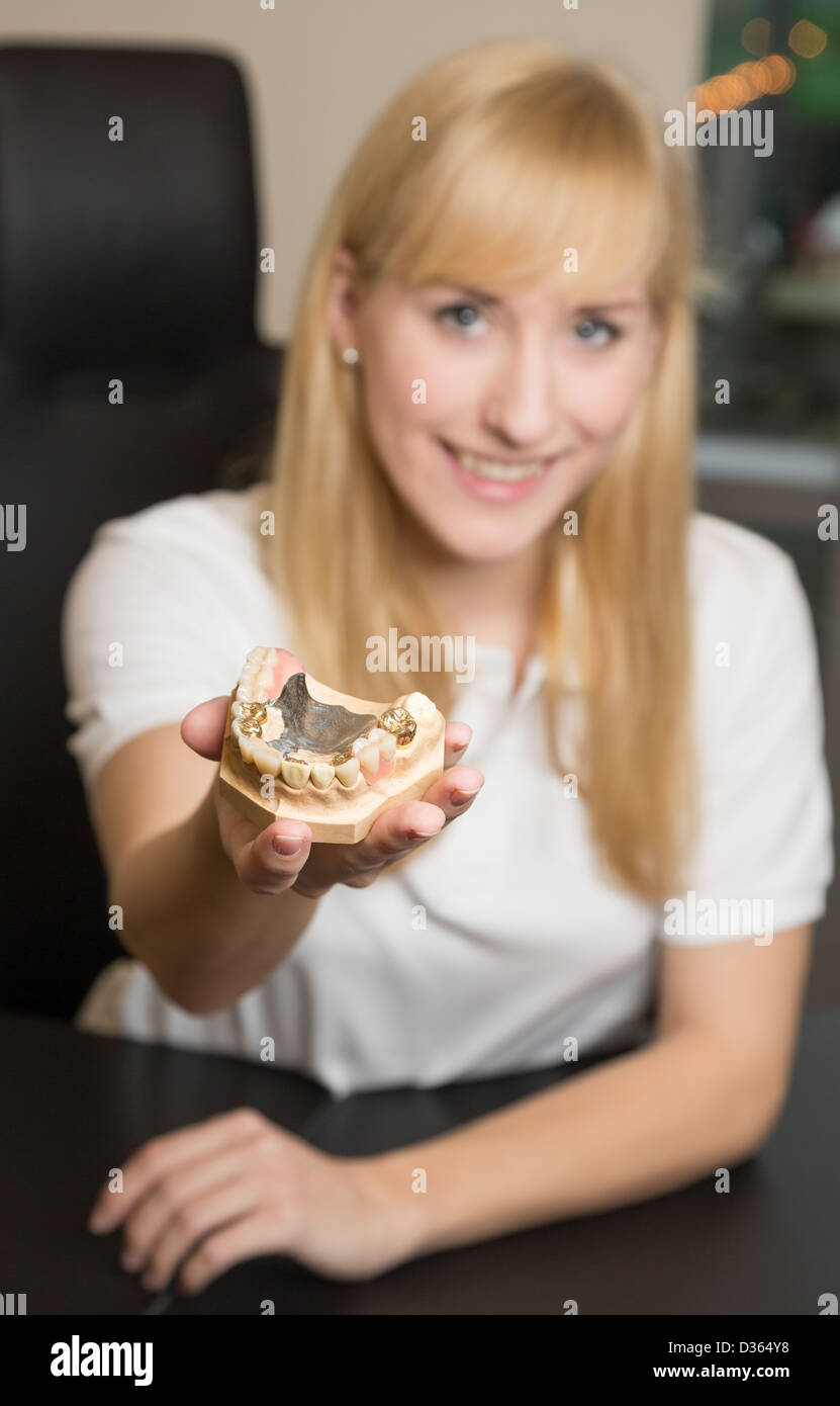 Dental technician presenting prosthesis in the office Stock Photo - Alamy