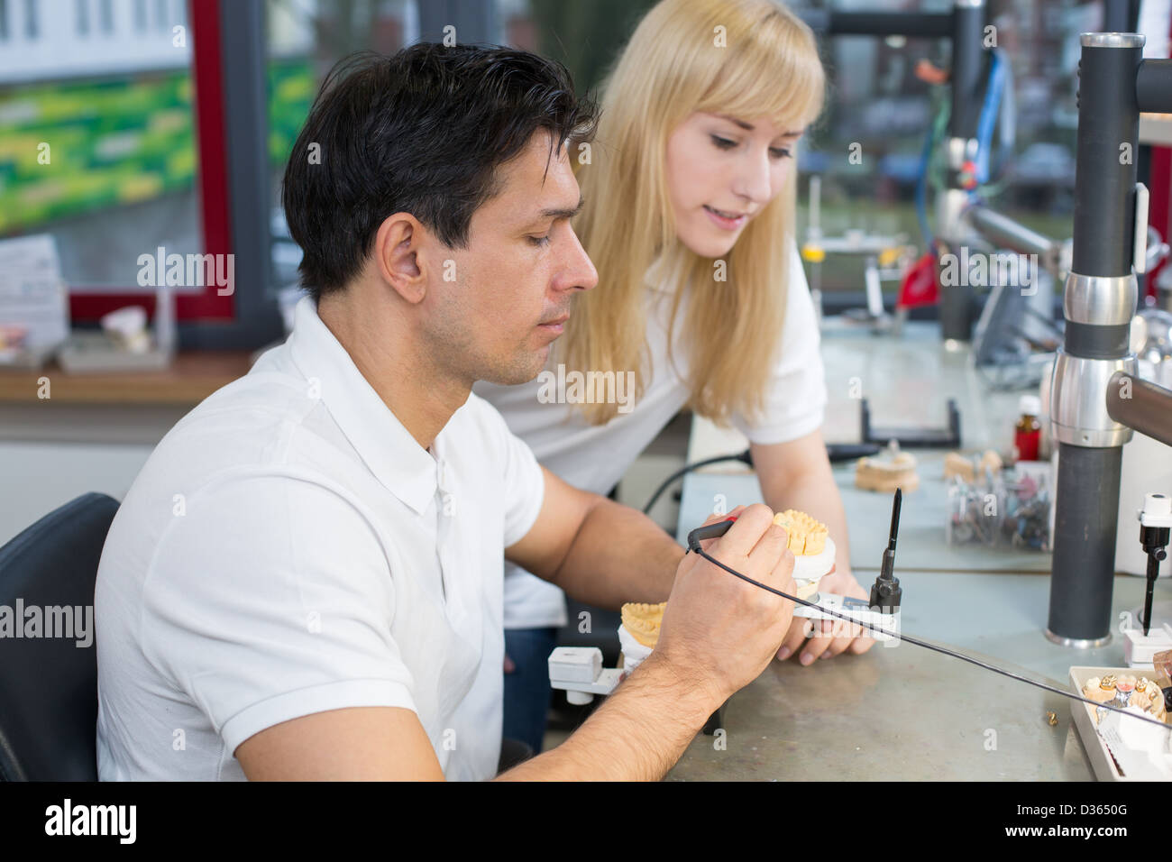 Instructor in a dental lab instructing an apprentice Stock Photo - Alamy