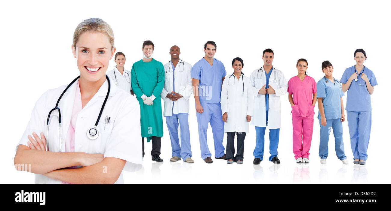 Smiling doctor standing in front of her medical team in line Stock ...