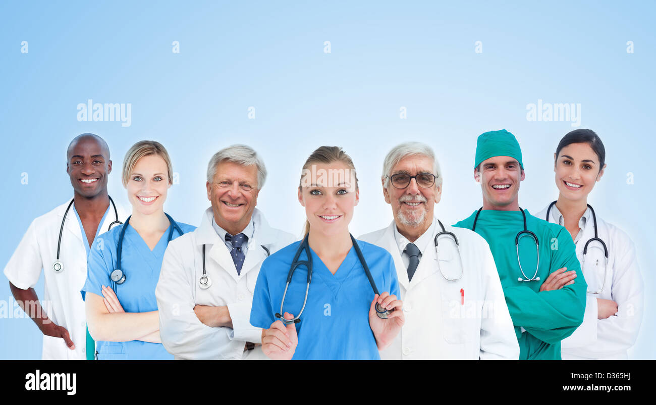 Medical team standing in line on blue background Stock Photo - Alamy