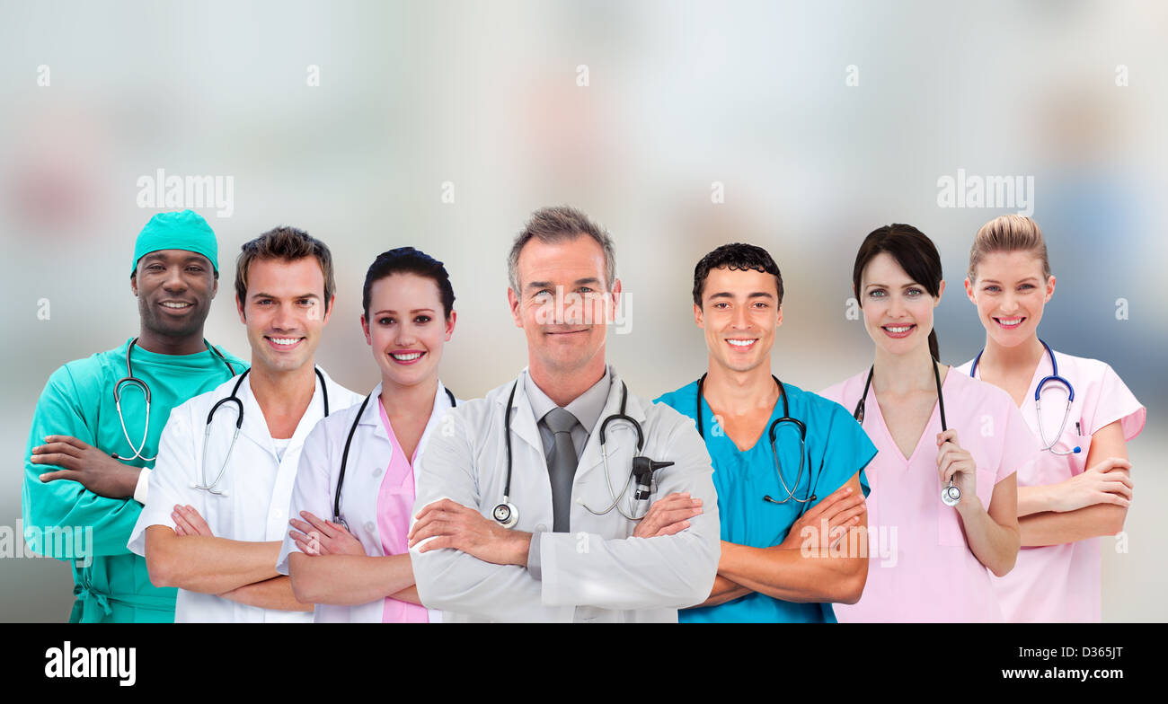 Medical team standing arms crossed in line Stock Photo - Alamy