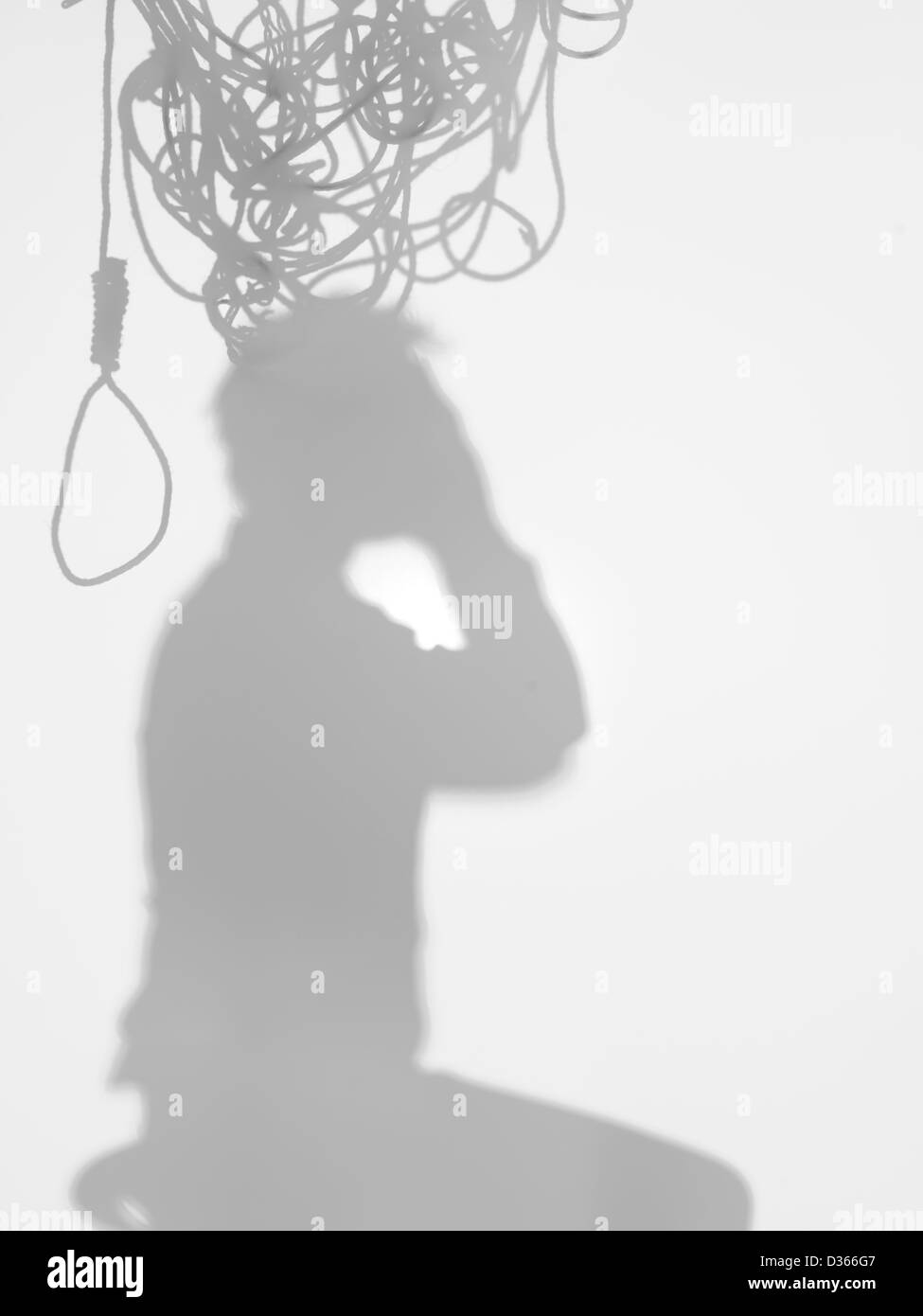 side view of man sitting with a despair gesture with tangled hanging ...